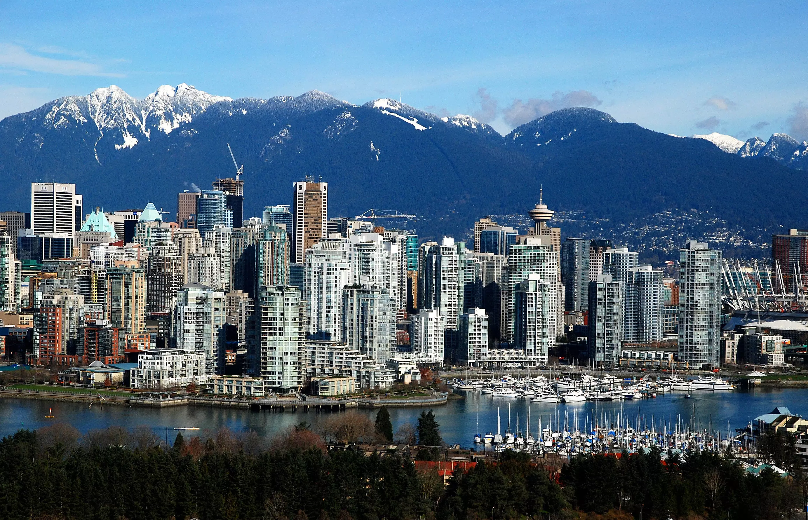 Vancouver na may False Creek sa harapan at Grouse Mountain at North Shore Mountains sa background.