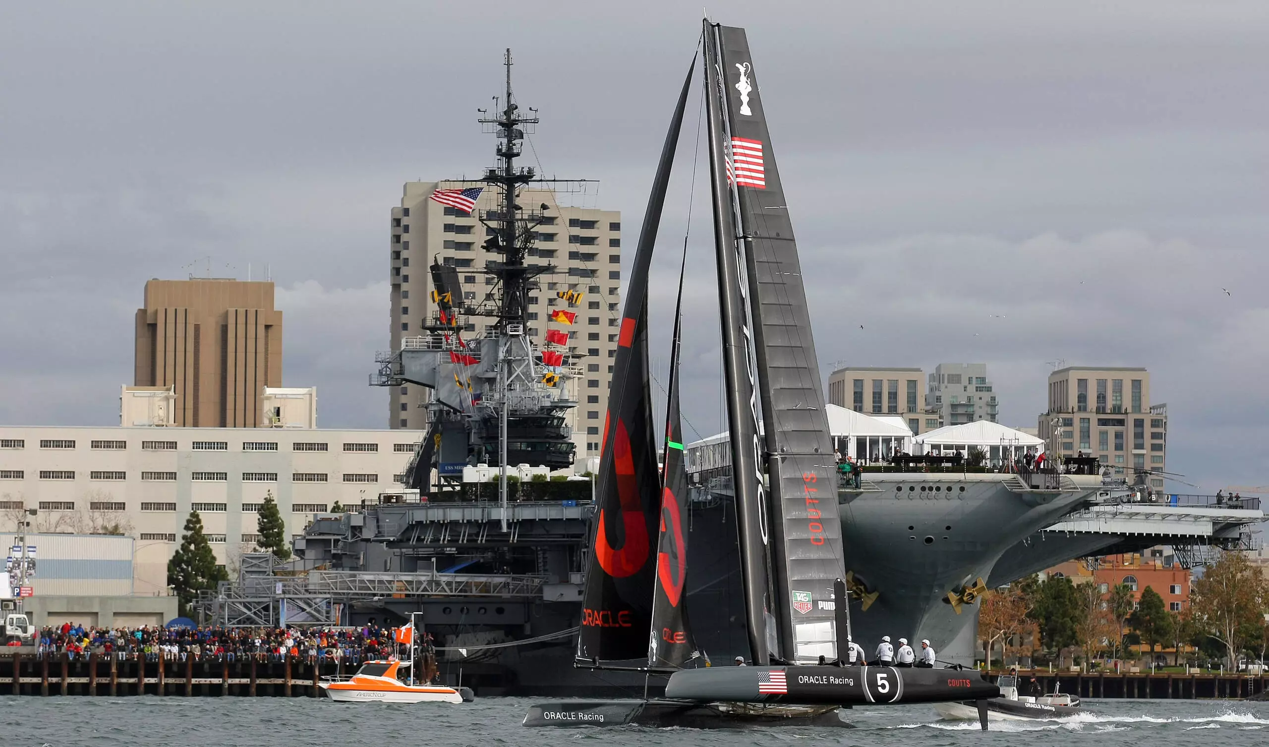 SAN DIEGO, CA - 20 NËNTOR: Oracle Racing 5 - Coutts konkurron në AC500 Speed Trial përpara horizontit të San Diegos dhe U.S.S. Midway gjatë Serisë Botërore të Kupës së Amerikës, Gara e Flotës së Kampionatit të Garave të Ndeshjes në San Diego më 20 nëntor 2011 në Gjirin e San Diegos në San Diego, Kaliforni. (Foto nga Donald Miralle/Getty Images)